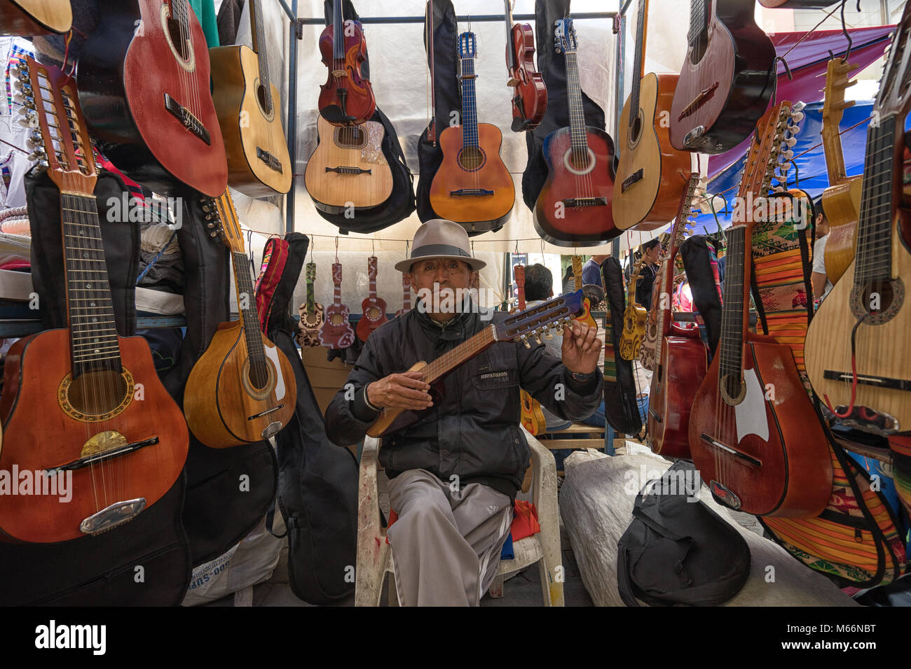 Otavalo, Ecuador - February 17, 2018: man selling string intruments in ...