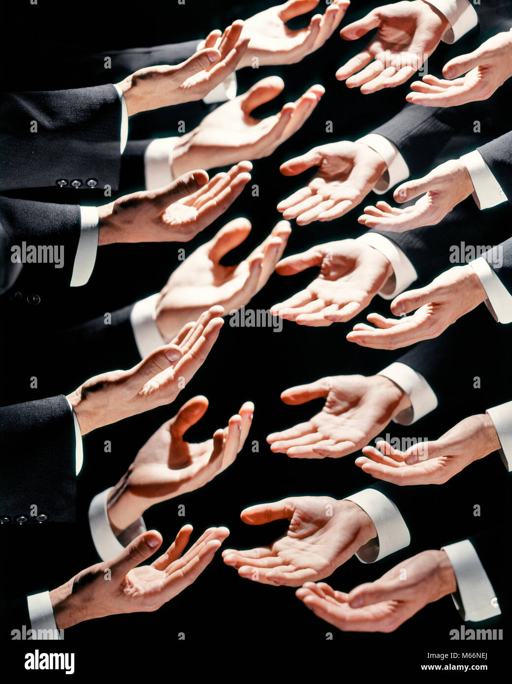 1960s MULTIPLE EXPOSURE OF MALE HANDS OFFERING A HELPING HAND OR ASKING ...