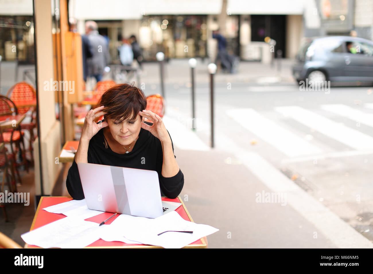 aged female screenwriter working with scenario in laptop Stock Photo ...
