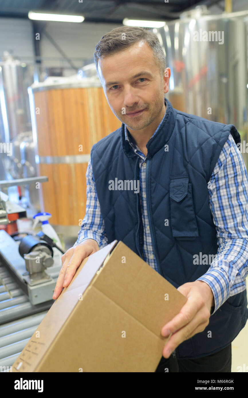 smiling worker looking at camera in warehouse Stock Photo - Alamy