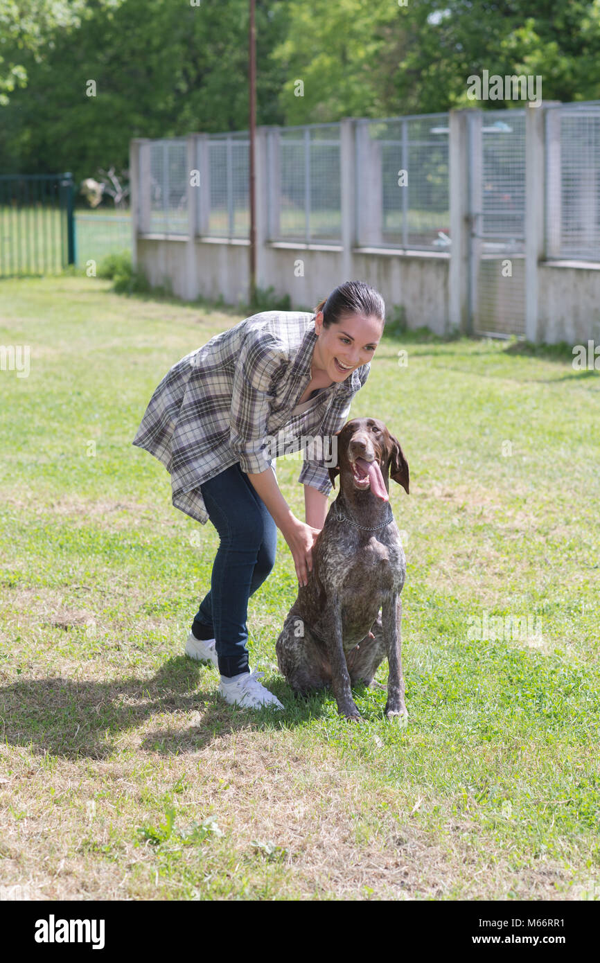 dedicated girl training dog in kennel Stock Photo - Alamy