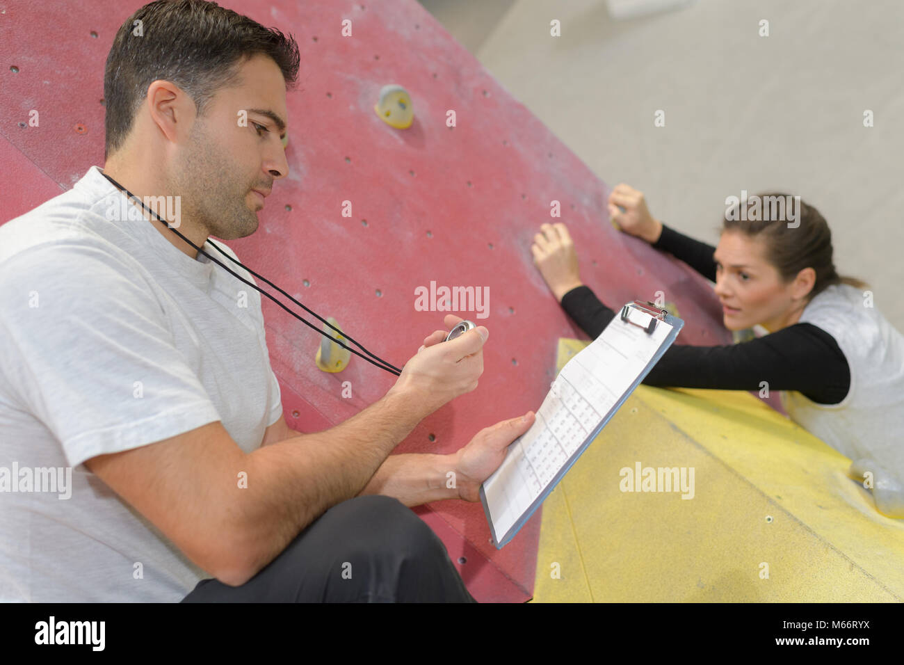 coach and female climber at indoor climbing club Stock Photo - Alamy