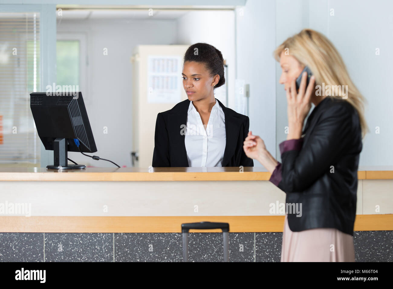 Guest standing hotel front desk hi-res stock photography and images - Alamy