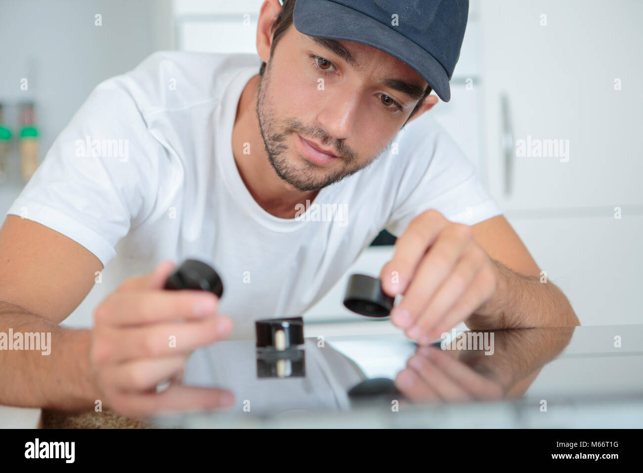 Workman holding black objects Stock Photo - Alamy