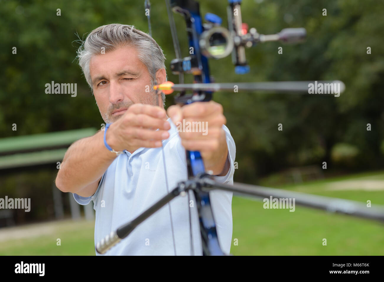 Man aiming archery bow Stock Photo - Alamy