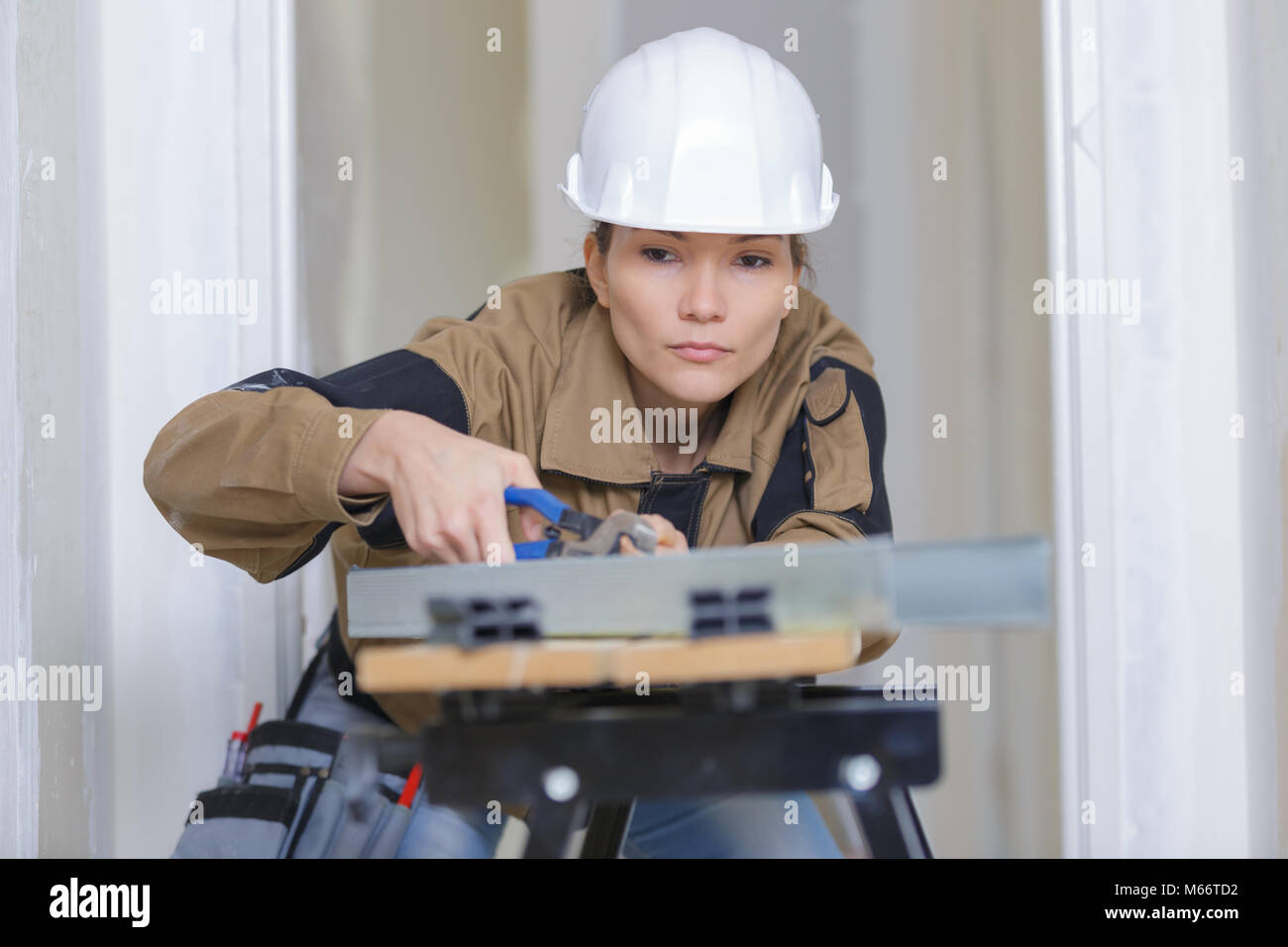 female worker using pliers working on workbench Stock Photo - Alamy