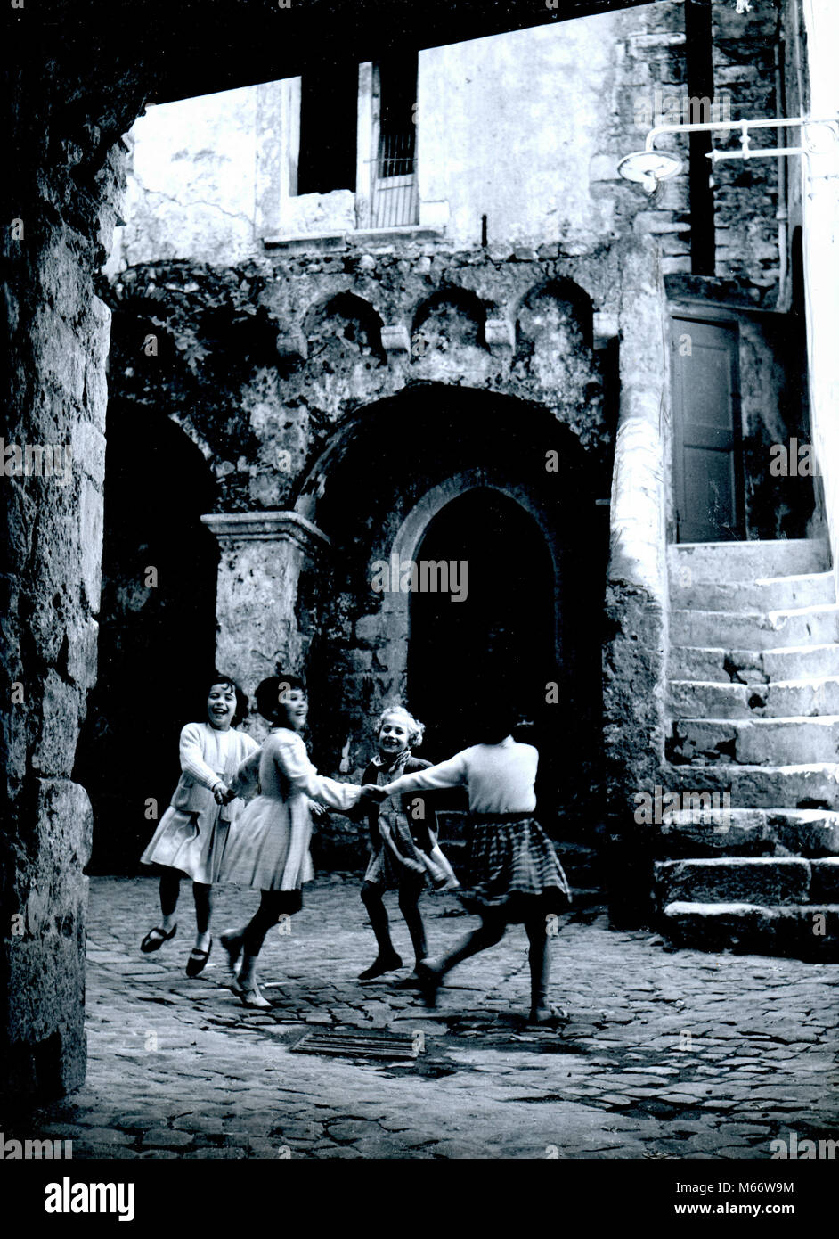 Children playing at medieval neighborhood, Terracina, Italy 1959 Stock ...