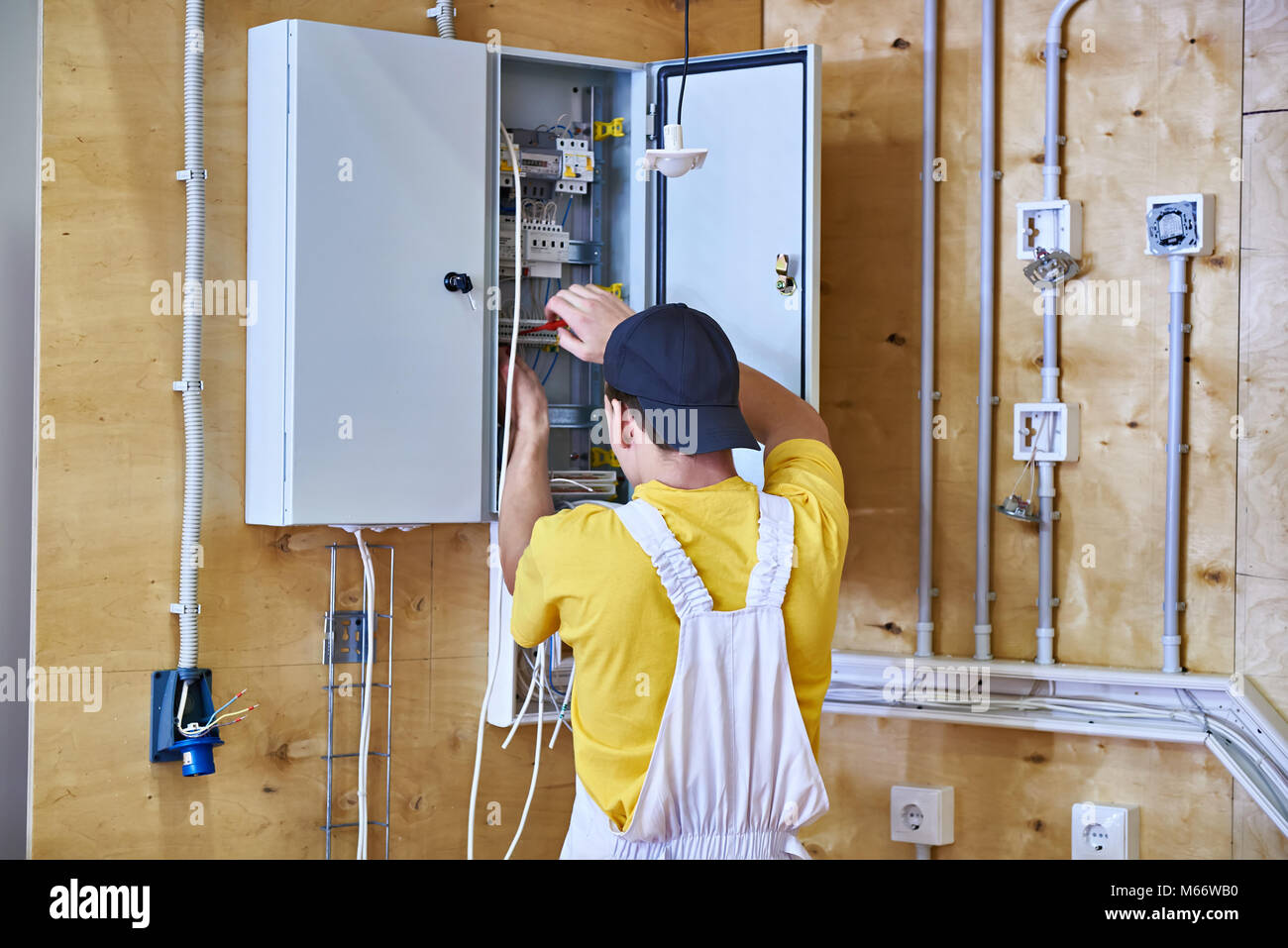 Electrician makes wiring in an electrical switchboard Stock Photo - Alamy