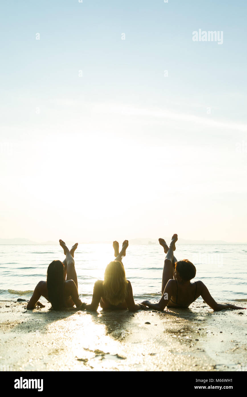three girls on the beach at sunset Stock Photo - Alamy