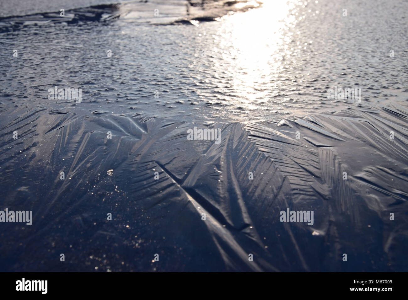 frozen structures on a lake with reflexions of sunlight Stock Photo - Alamy