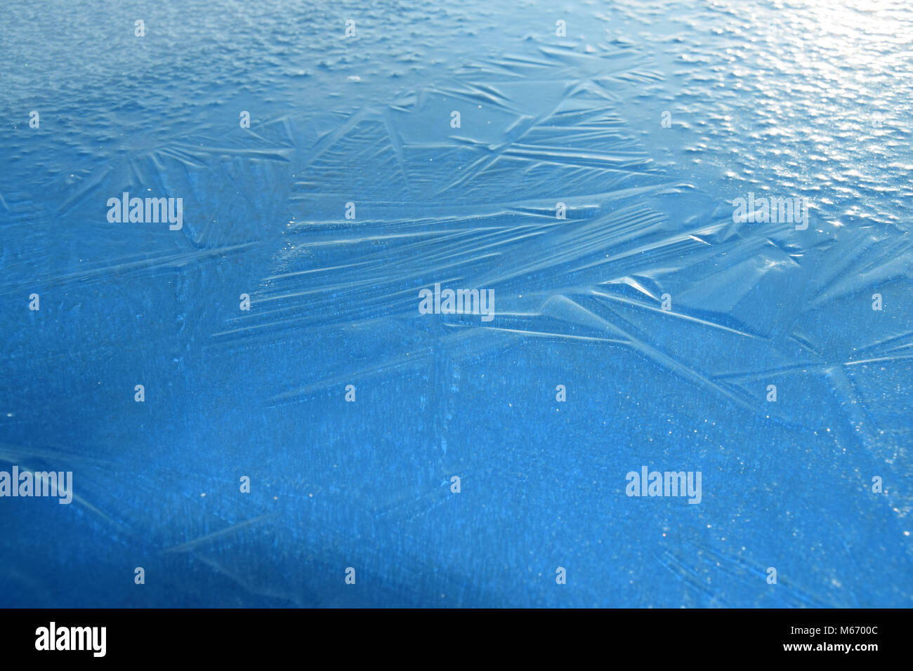 frozen structures on a lake with reflexions of sunlight Stock Photo - Alamy