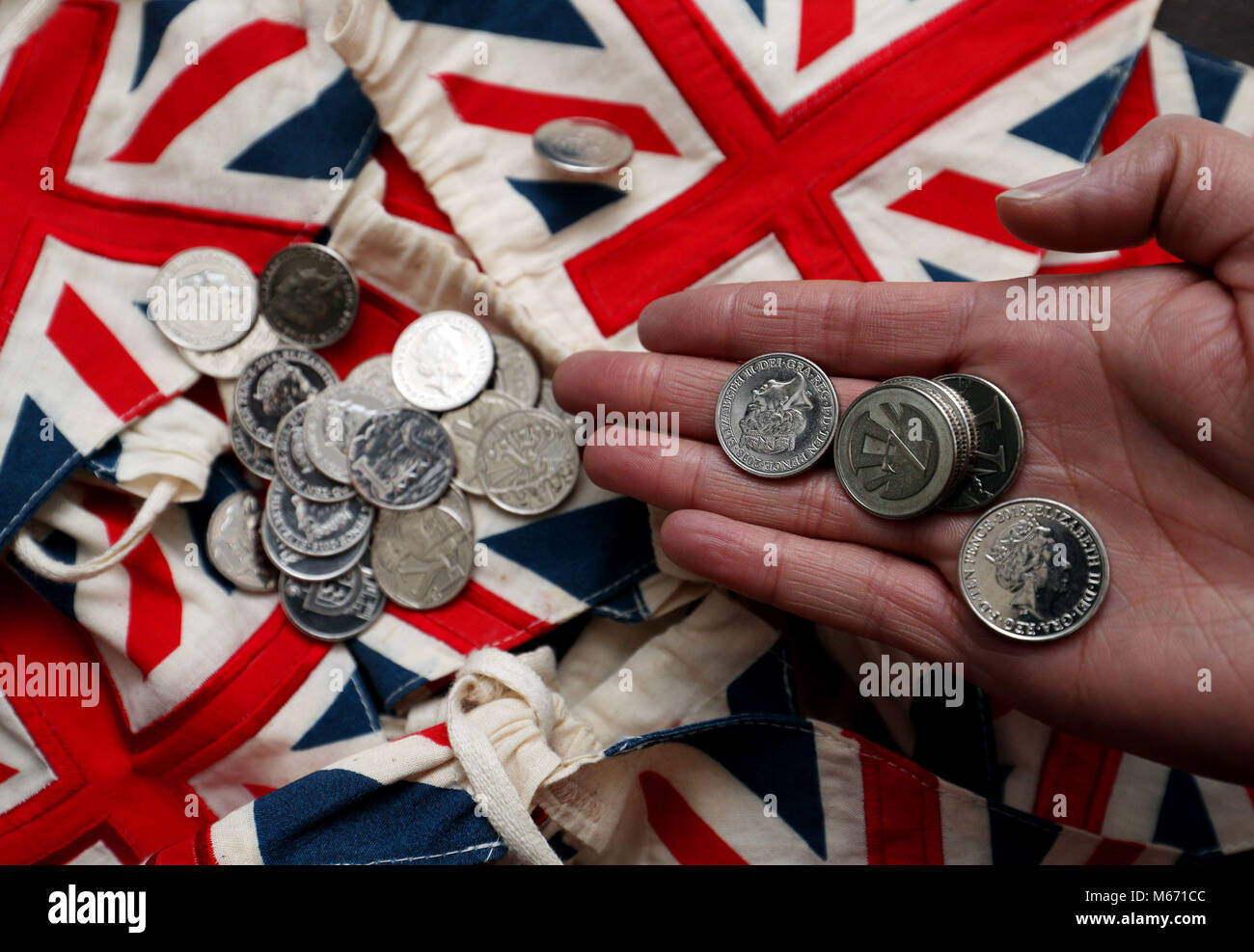 A Royal Mint employee displays some of the 26 brand new 10 pence ...