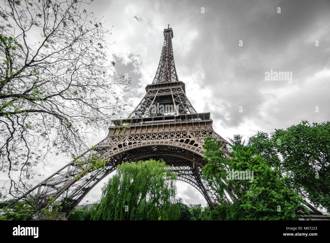 The Eiffel Tower bottom view over dark clouds Stock Photo - Alamy