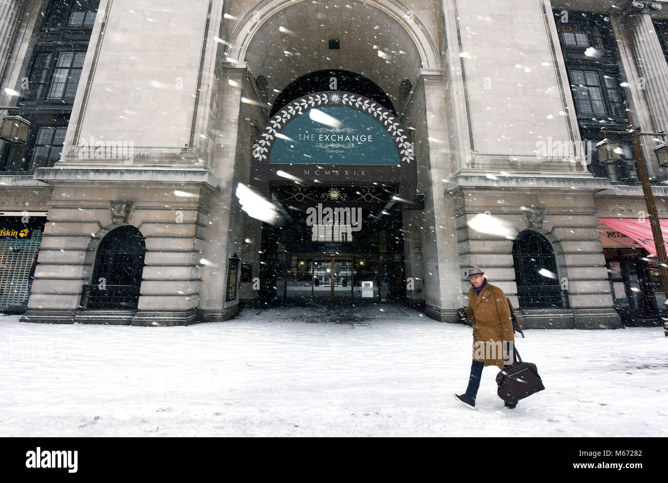 A commuter walks past the Exchange building in Nottingham, as another ...