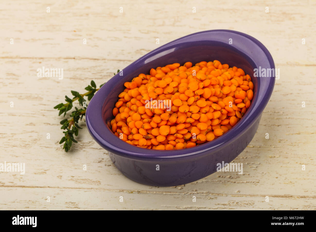 Orange lentil in the bowl over wooden background Stock Photo - Alamy