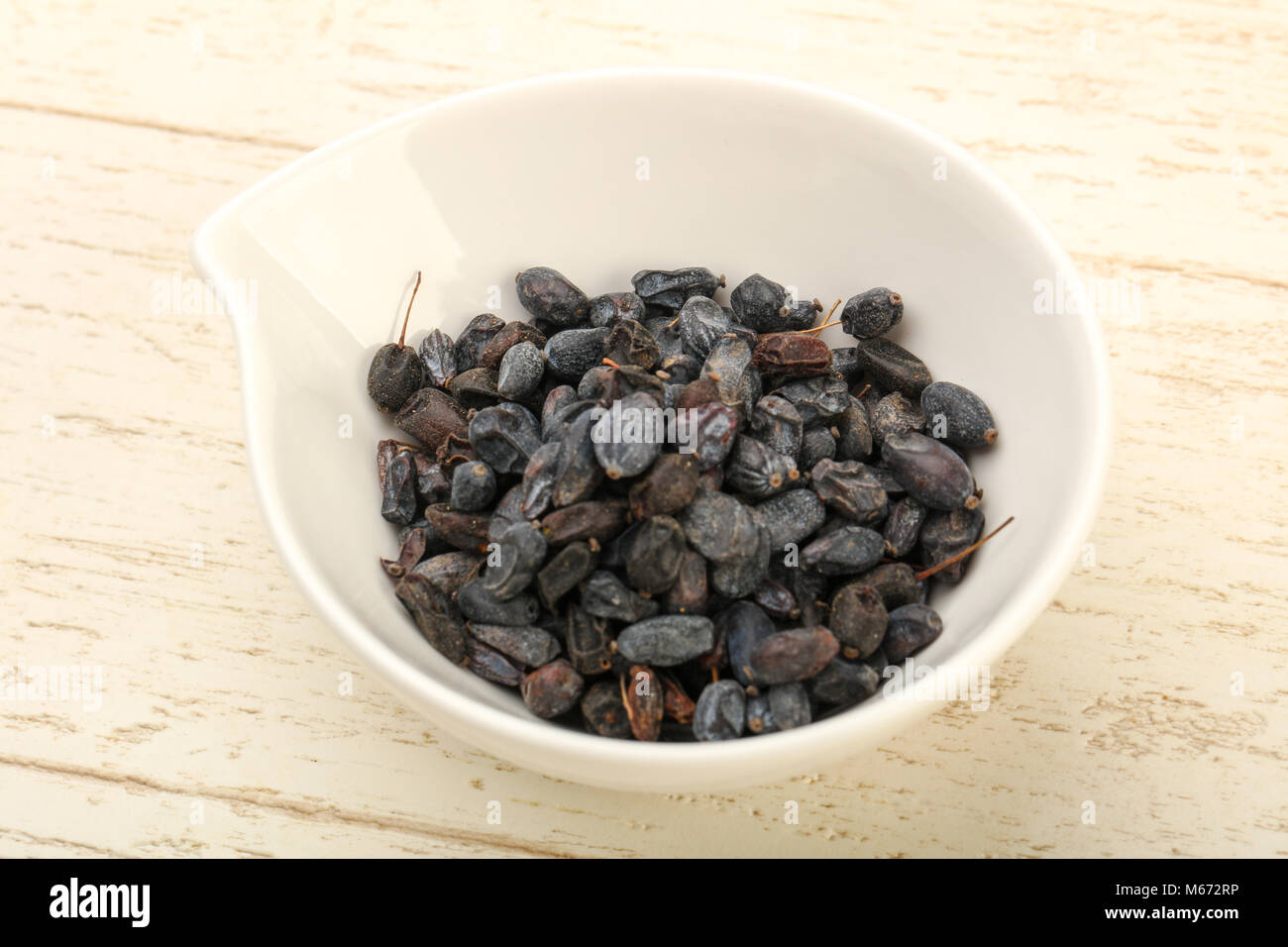 Dry barberry in the bowl over wooden background Stock Photo - Alamy