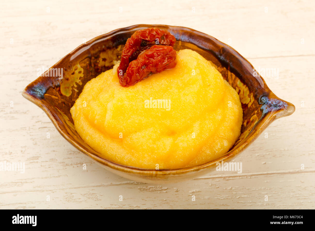 Polenta with dry tomato Stock Photo - Alamy