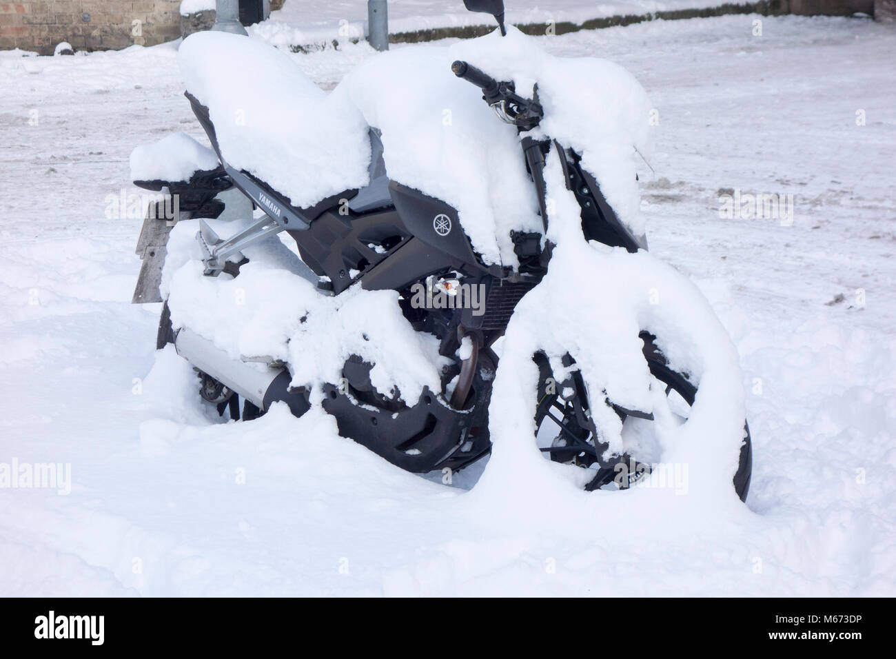Motorbike covered in snow Stock Photo - Alamy