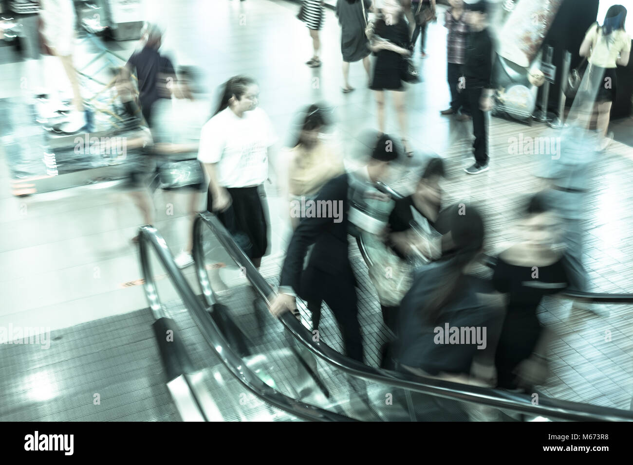 People using escalator - moving blur Stock Photo - Alamy