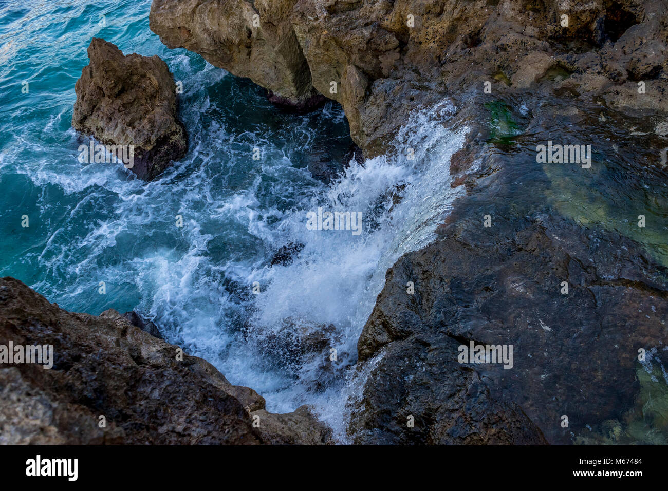 Rocks by the sea with waves of the Mediterranean sea next to the Cabo ...
