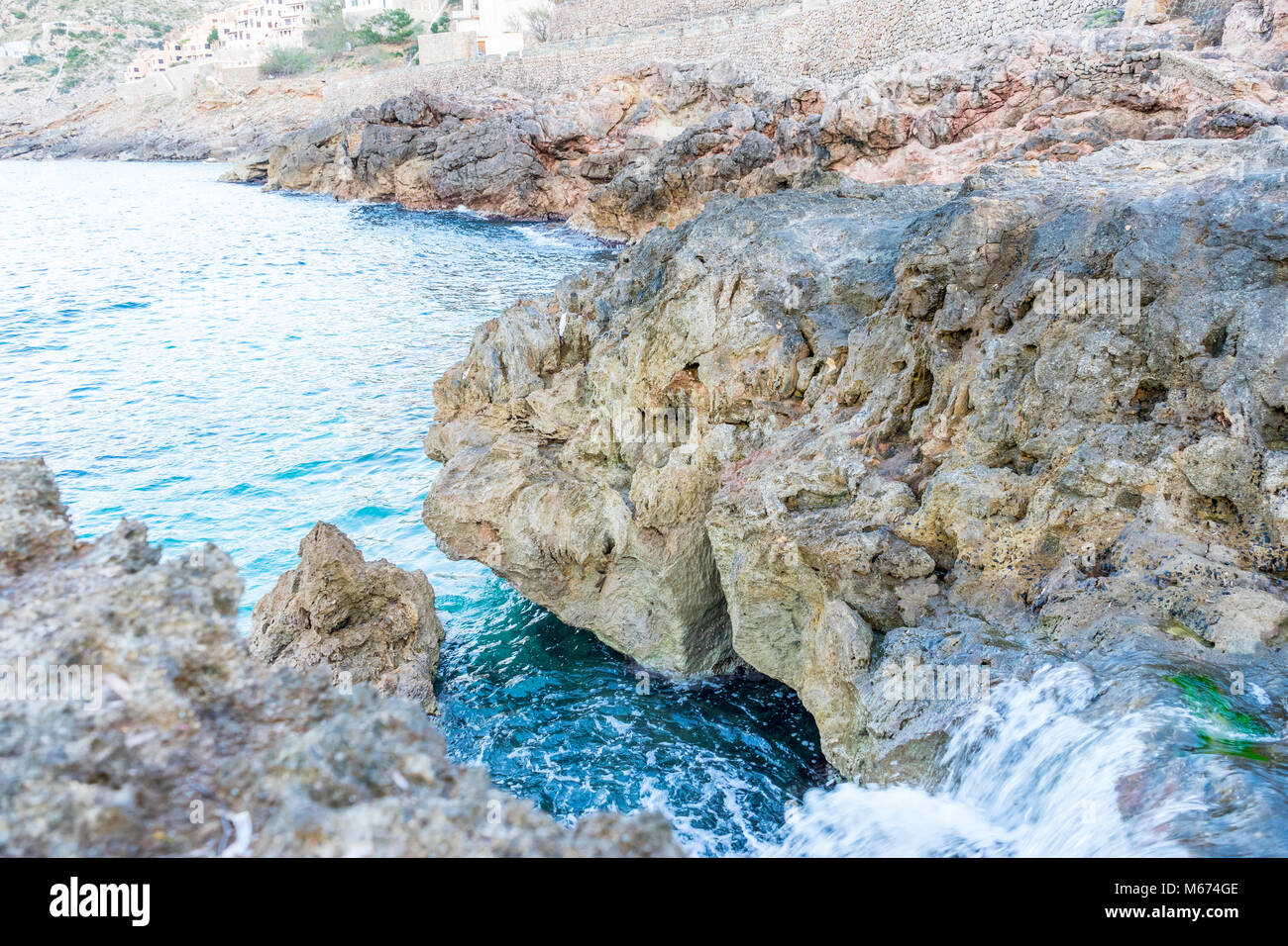 Rocks by the sea with waves of the Mediterranean sea next to the Cabo ...