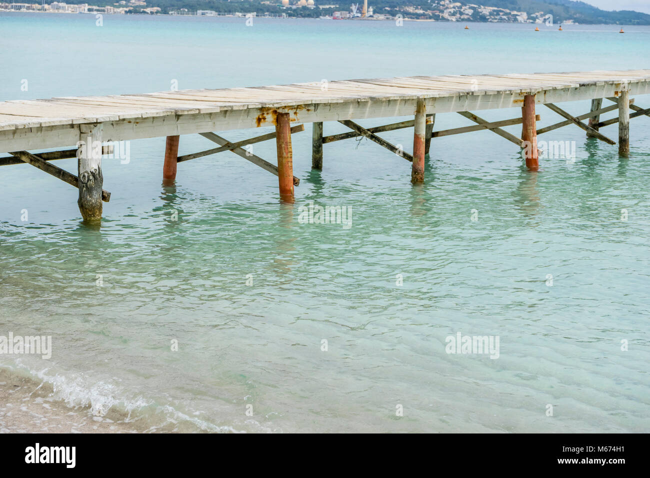 Wooden pier next to the Mediterranean sea on the island of Ibiza in ...