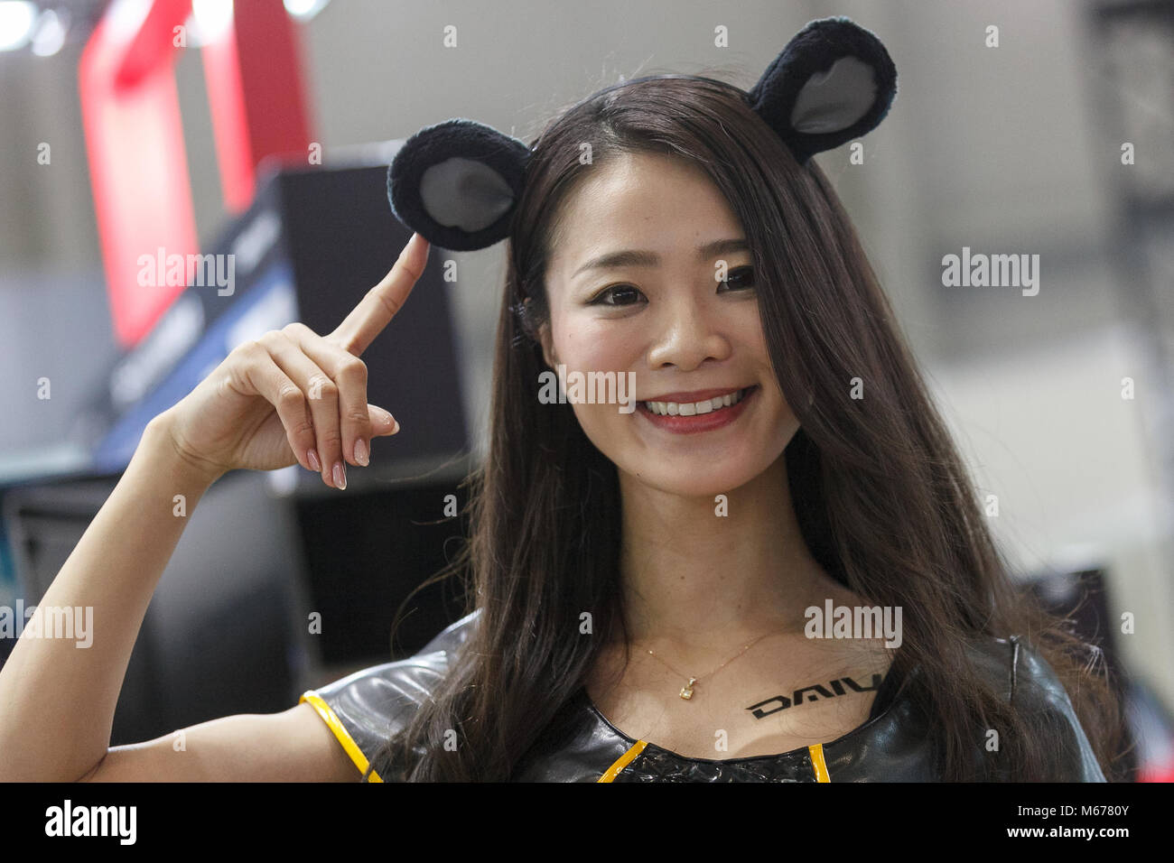 Yokohama, Japan. 1st Mar, 2018. A booth assistant poses for a ...