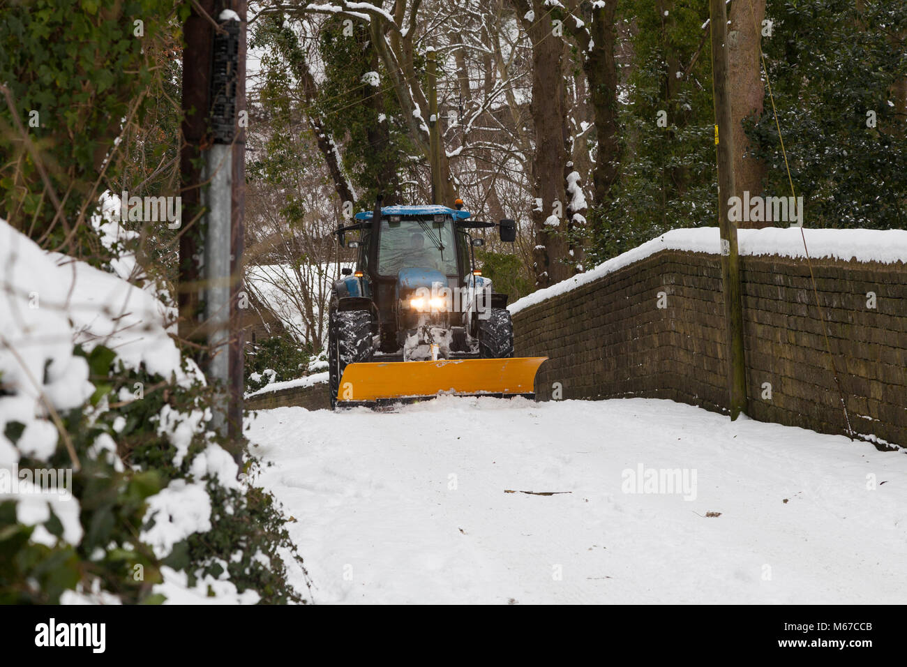 West Yorkshire. 1st Mar, 2018. UK Weather: A tractor with a plow clears ...