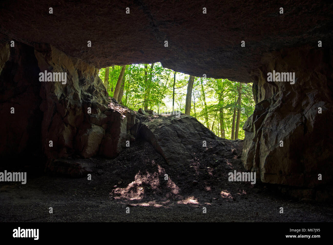 A window view of trees from a cave Stock Photo - Alamy