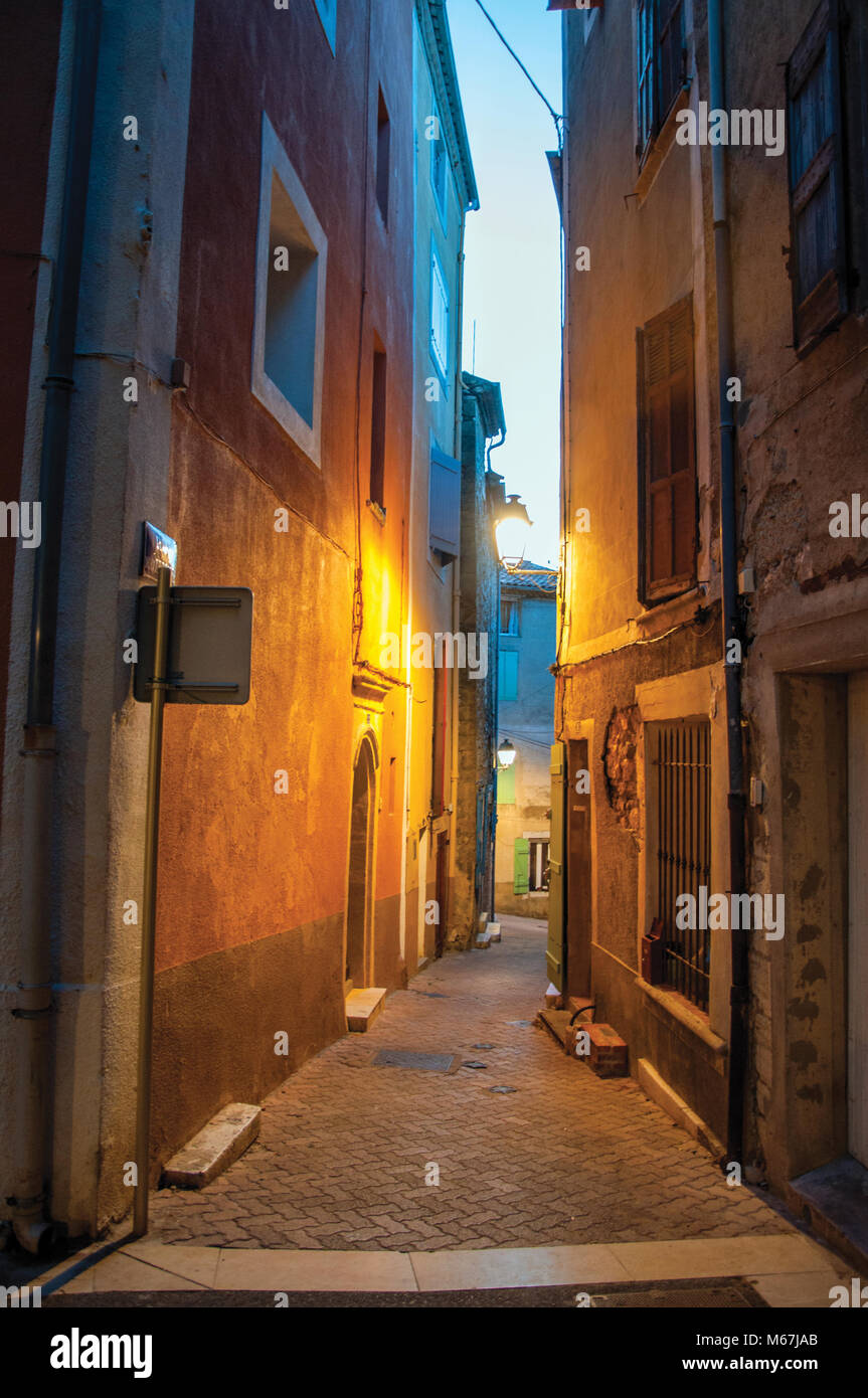 View of narrow alley in the early evening with lamp lit, in the lovely ...