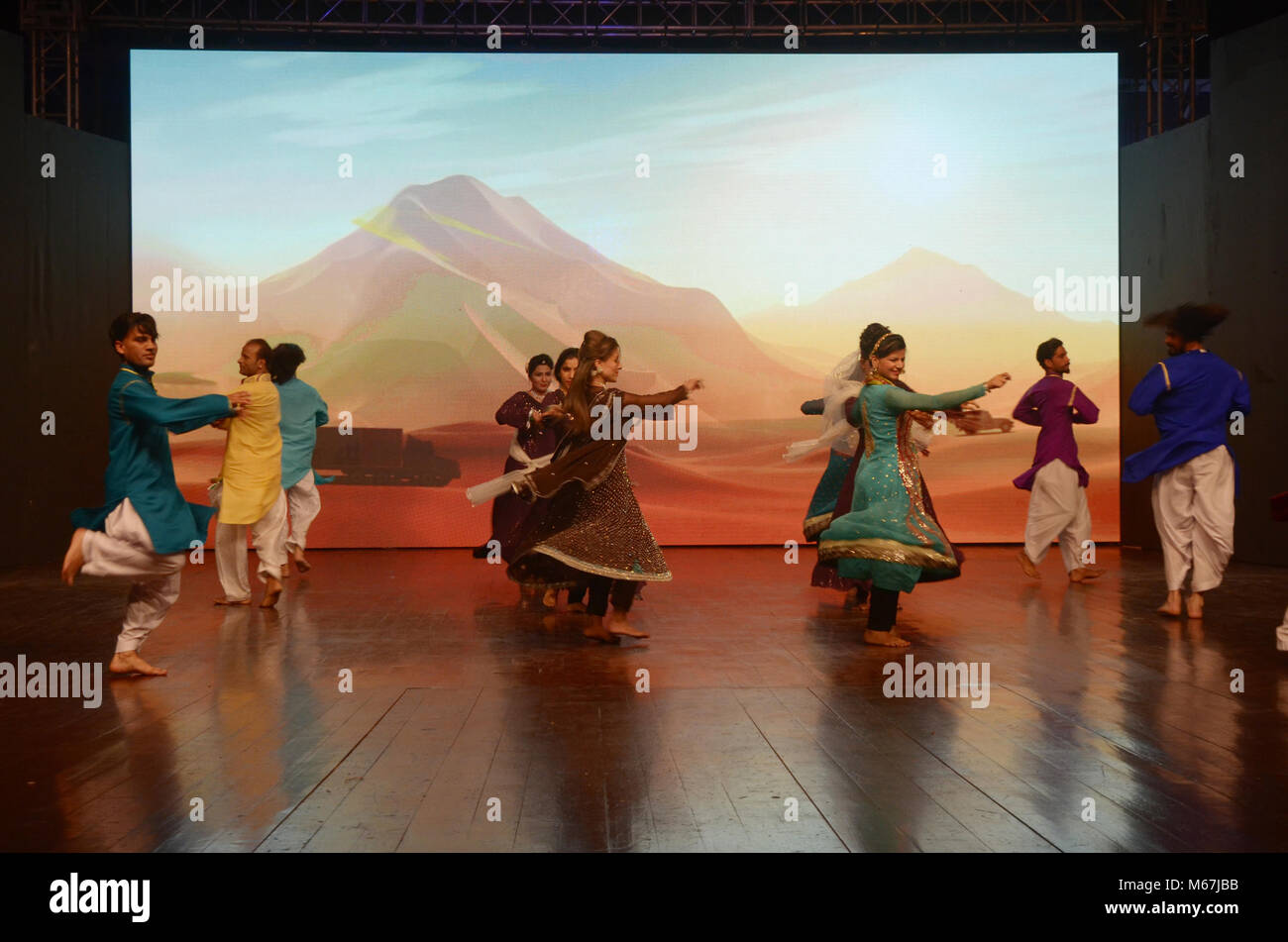 Pakistani and Chinese artist perform on stage wearing traditional ...