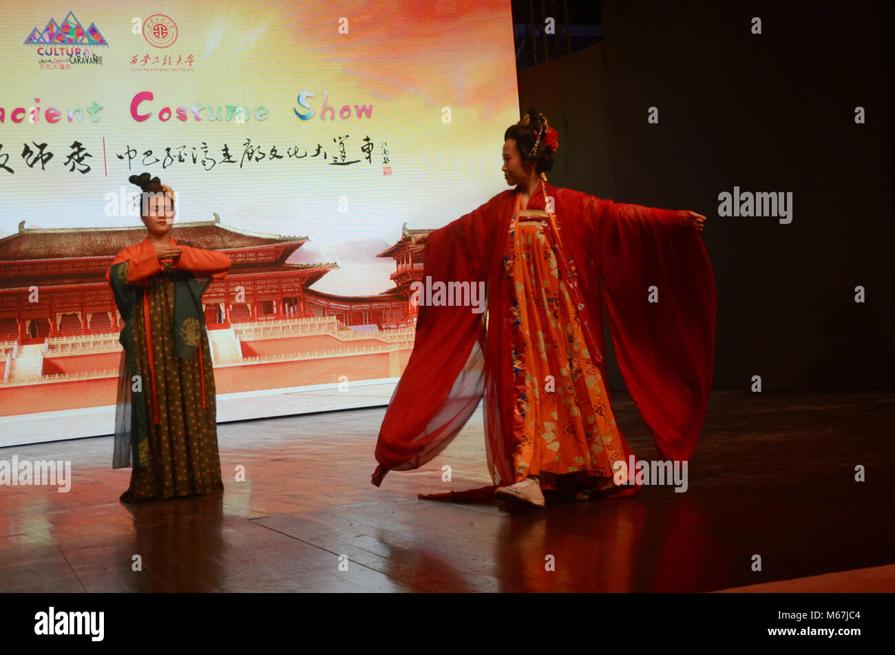 Pakistani and Chinese artist perform on stage wearing traditional ...