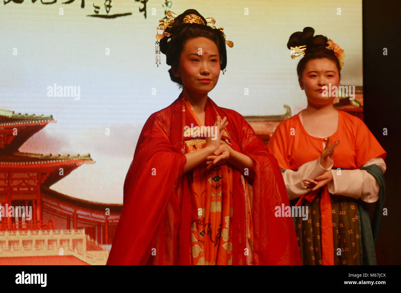 Pakistani and Chinese artist perform on stage wearing traditional ...