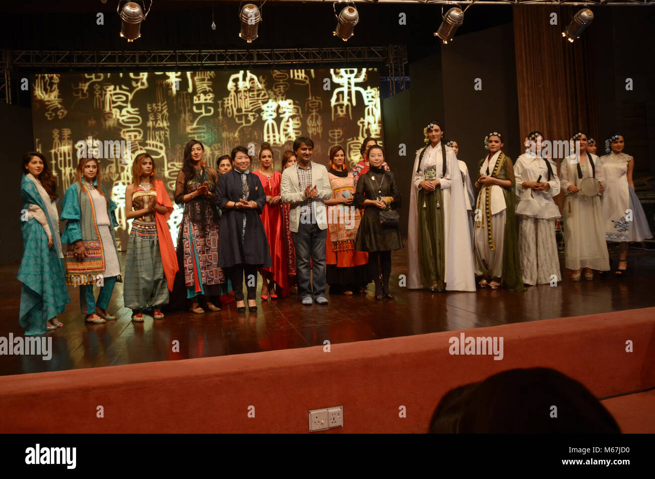 Pakistani and Chinese artist perform on stage wearing traditional ...