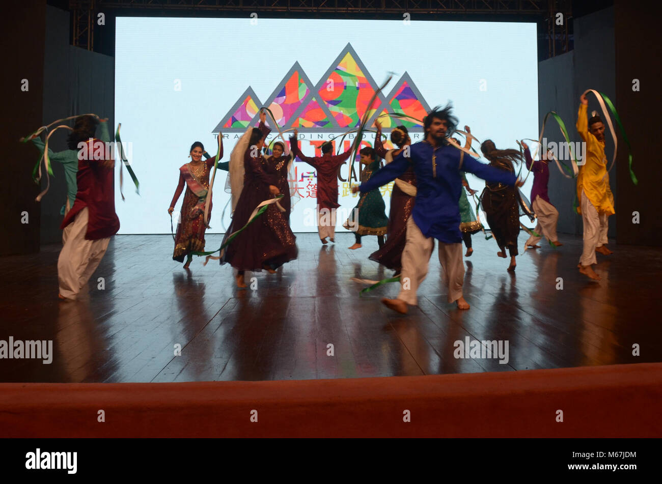 Pakistani and Chinese artist perform on stage wearing traditional ...