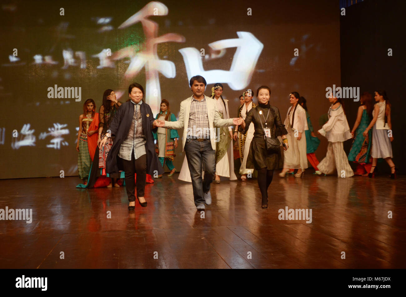 Pakistani and Chinese artist perform on stage wearing traditional ...