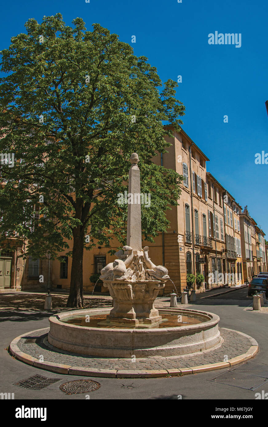 Street with buildings and fountain at Aix-en-Provence, a pleasant and ...