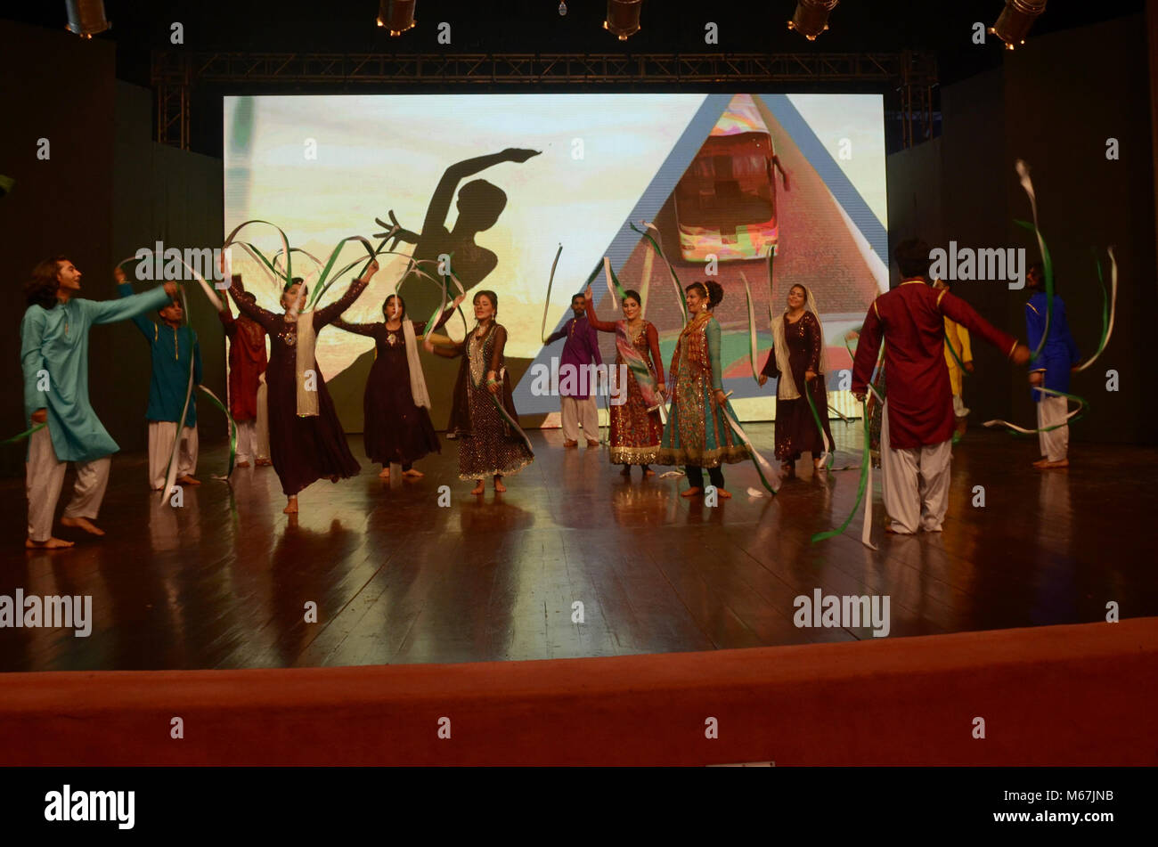 Pakistani and Chinese artist perform on stage wearing traditional ...