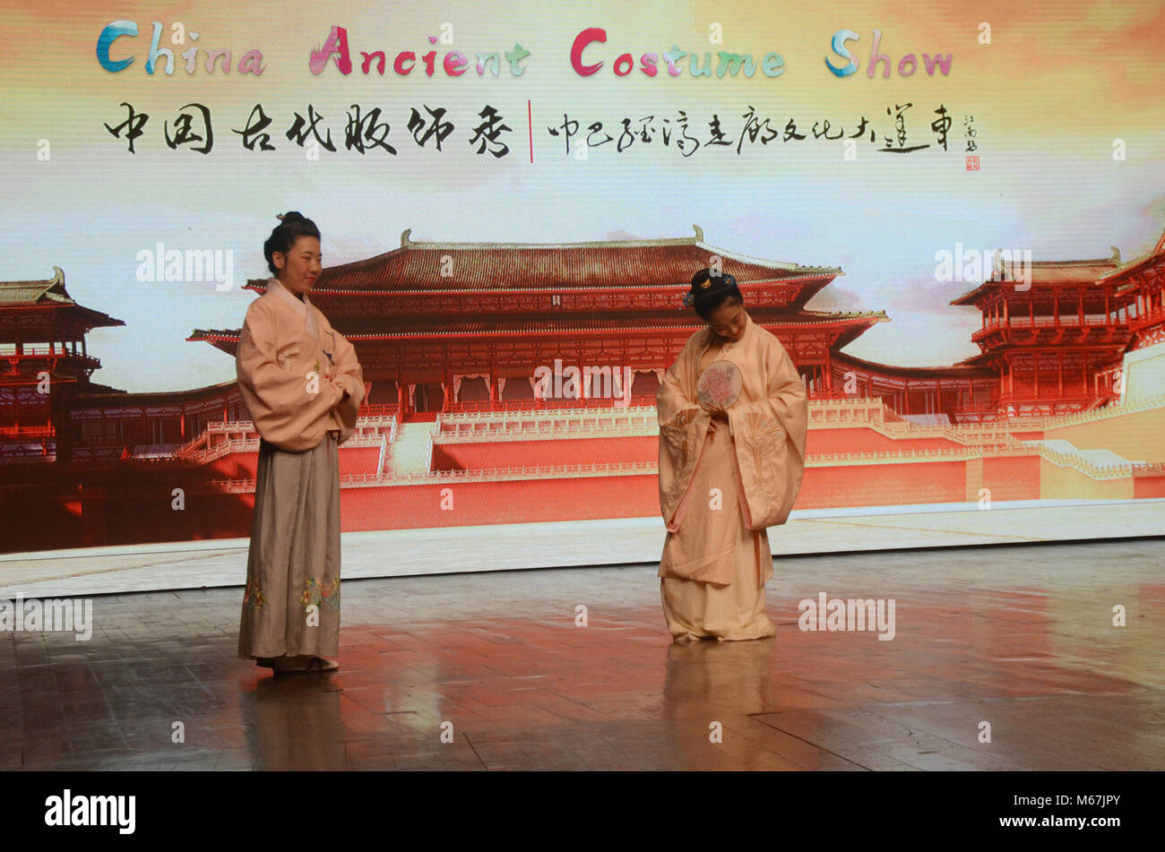 Pakistani and Chinese artist perform on stage wearing traditional ...