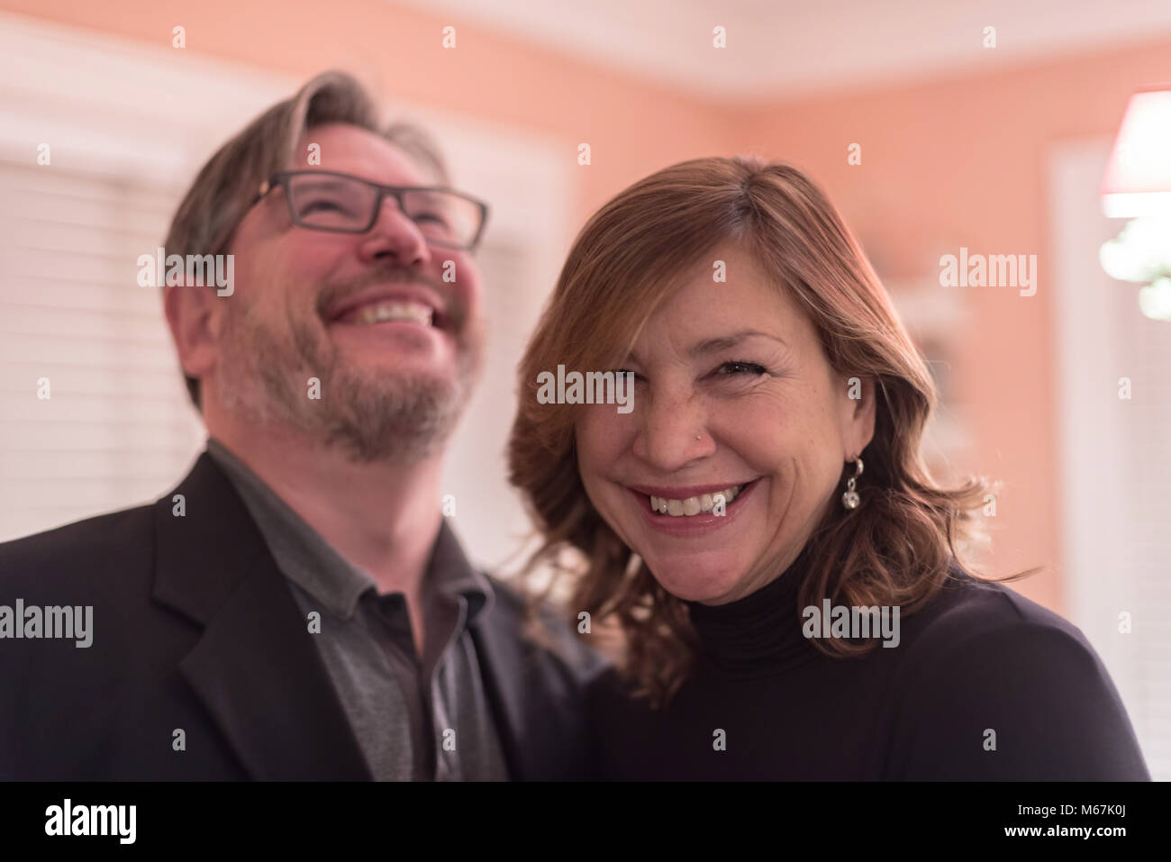 happy smiling couple laughing and having fun at friends party Stock ...