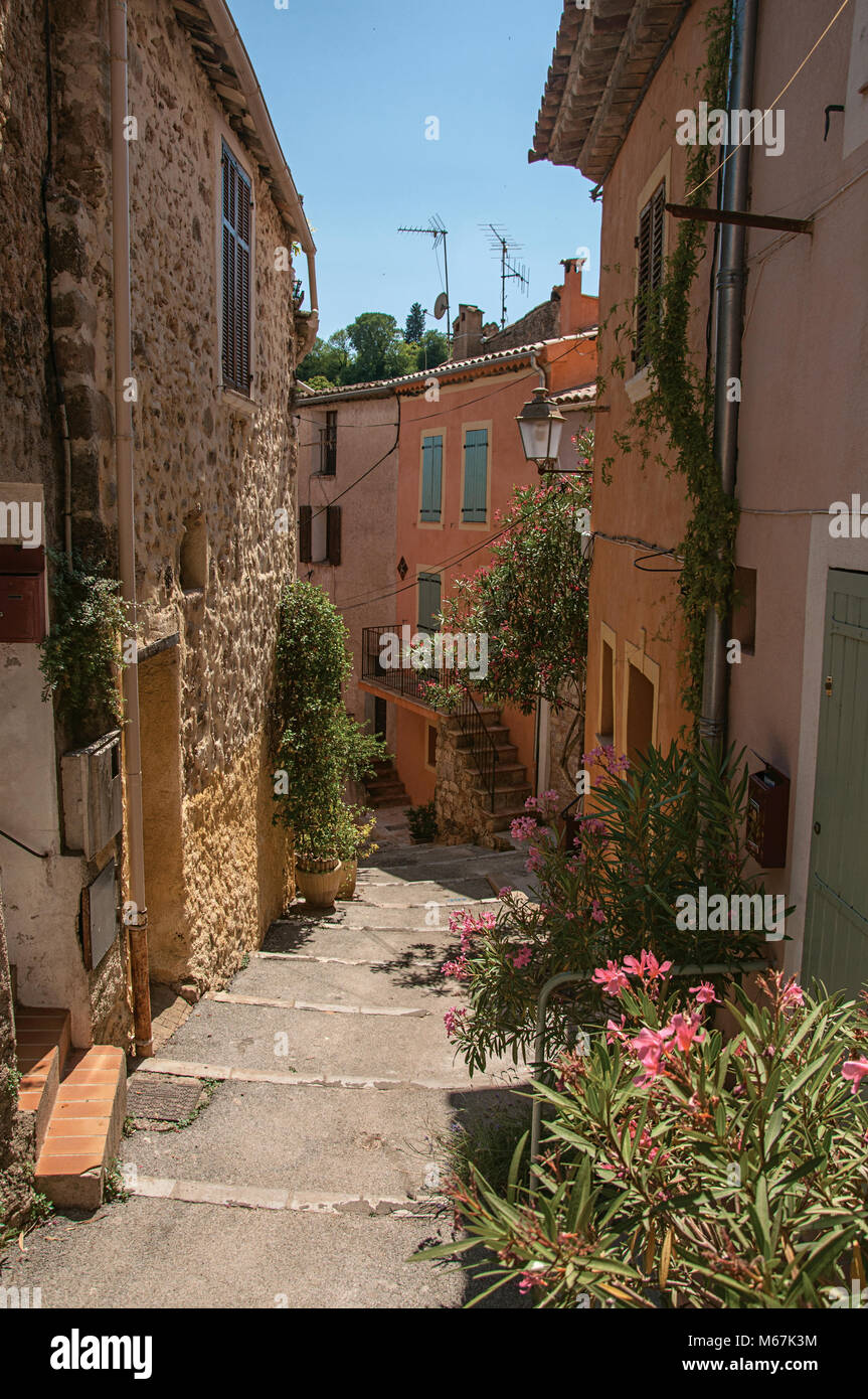 Stone houses in alley on the slope under blue sky, at the medieval Les ...