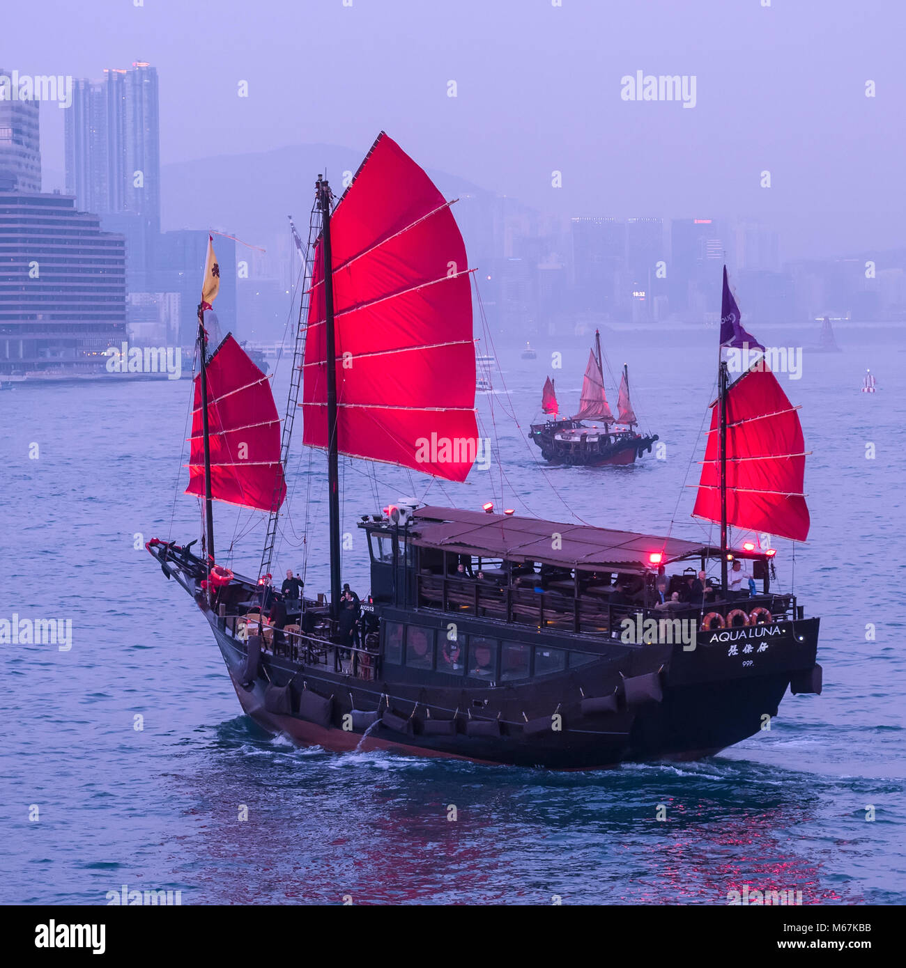 Traditional Chinese tourist junks sailing in polluted haze, Victoria ...