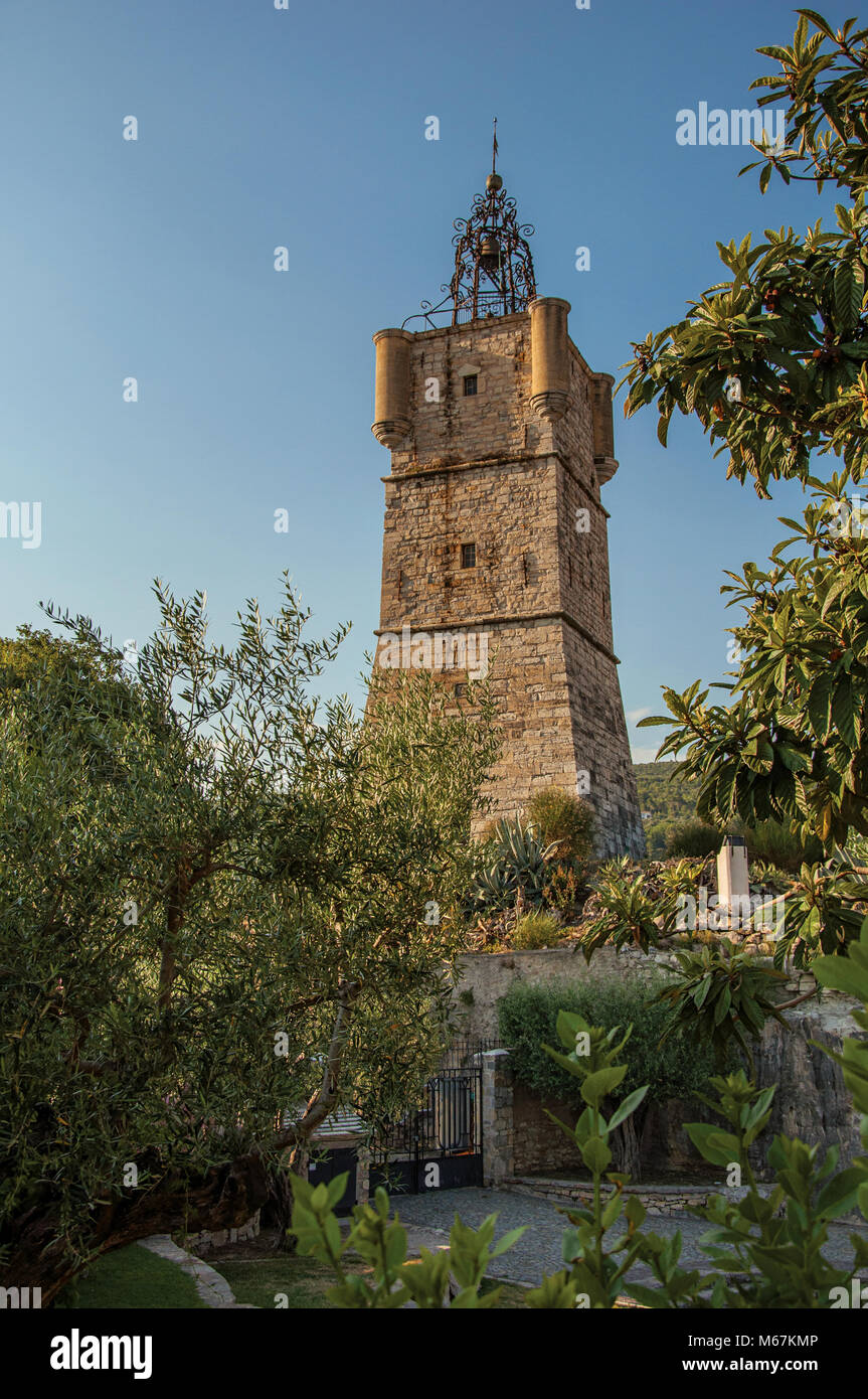 View of the clock tower made of stone on top of the hill with ...