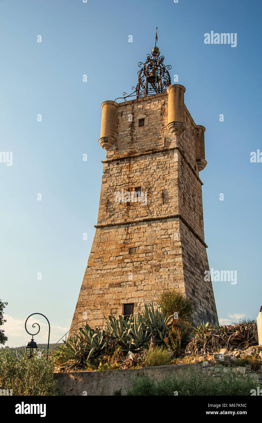 View of the clock tower made of stone on top of the hill with ...