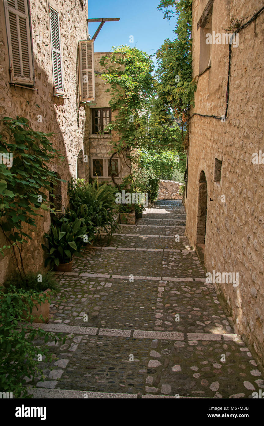View of alley with stone houses and slope in Saint-Paul-de-Vence, a ...