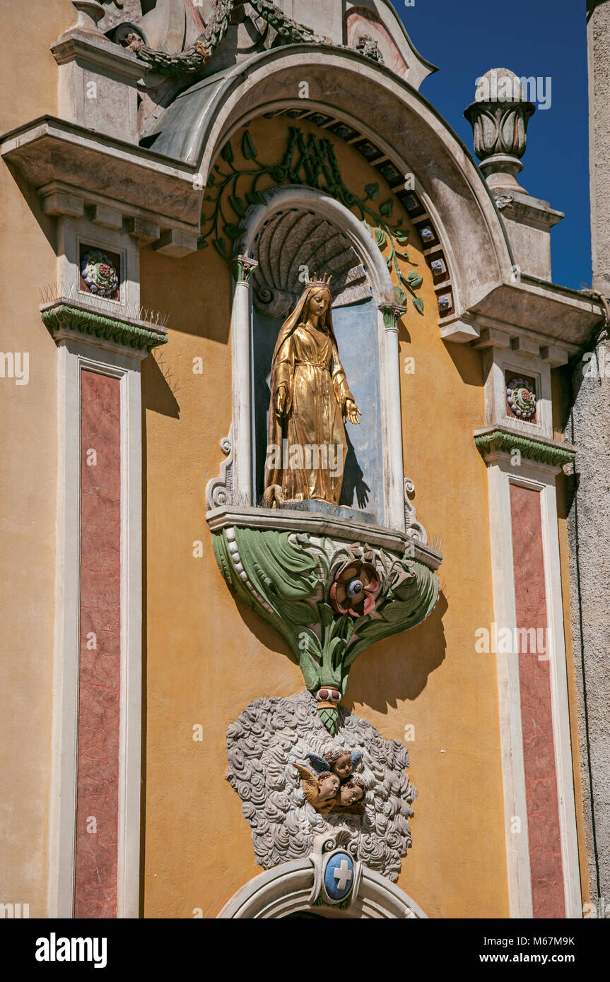 View of golden sculpture in niche of church facade of Vence, a stunning ...