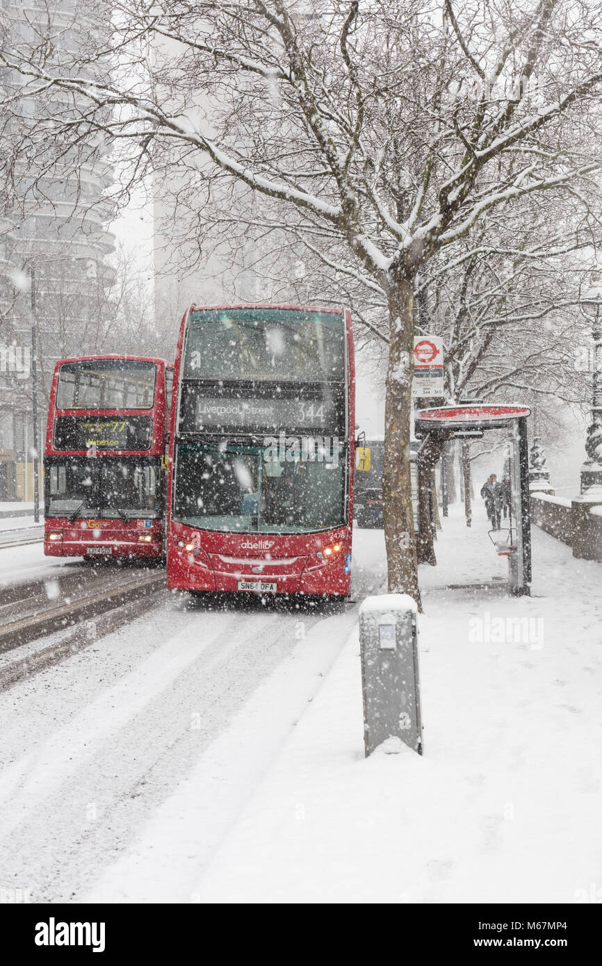 Two London Buses on the Road During Snowstorm Stock Photo - Alamy