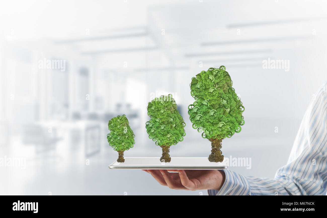 Eco green environment concept presented by tree as working mechanism or ...