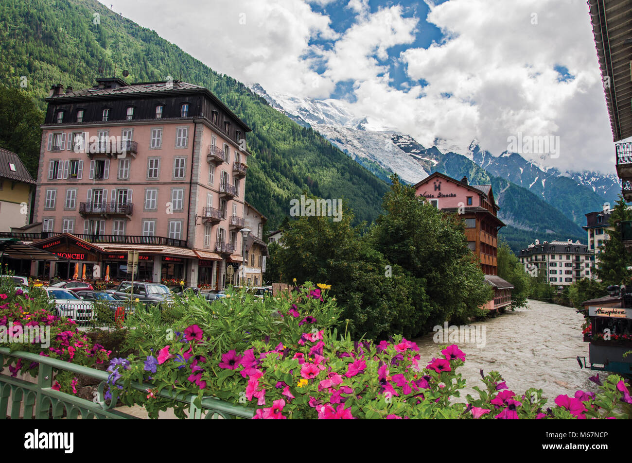 View of building, creek, flowers and the Mont Blanc in Chamonix, a ...