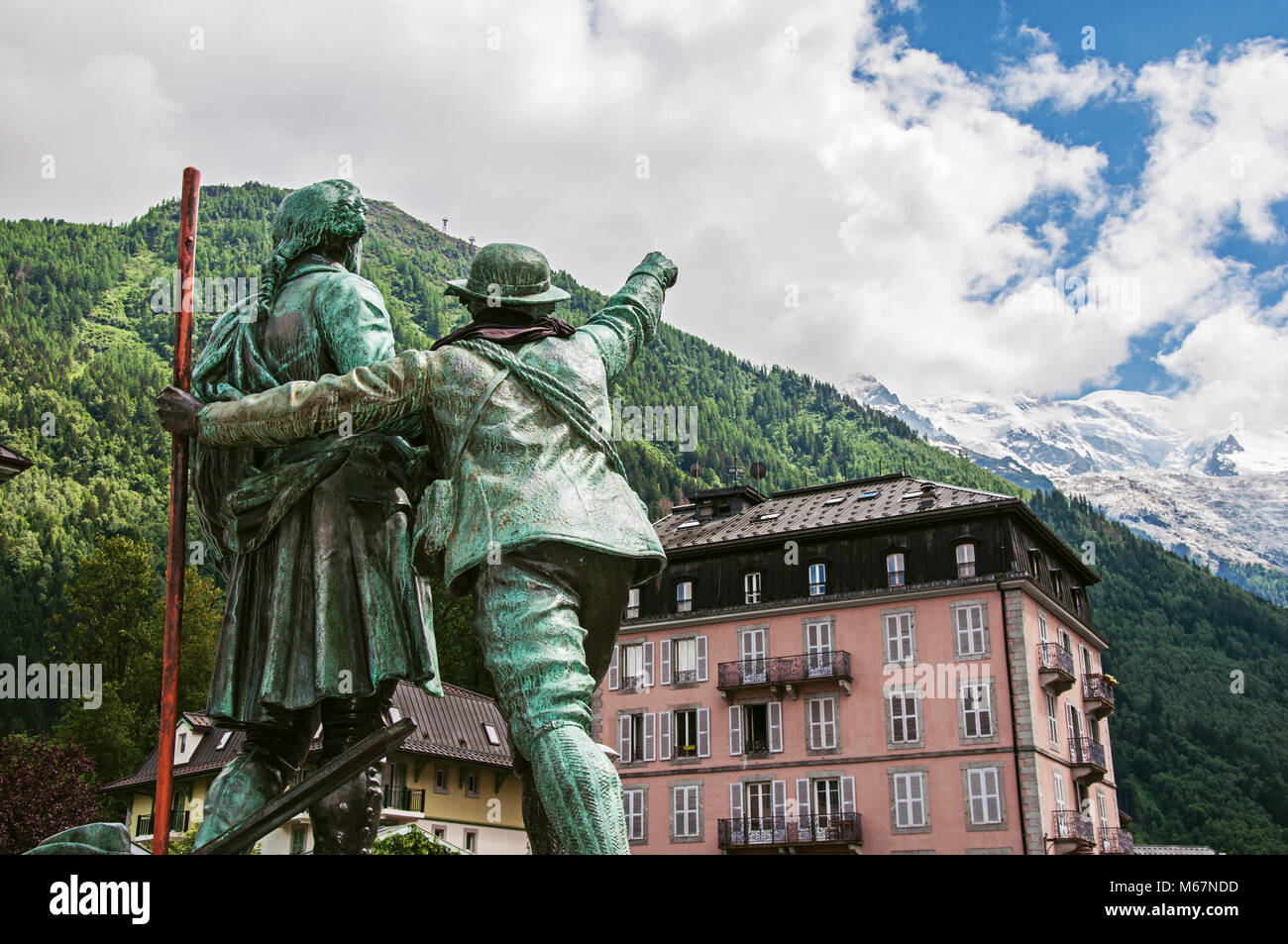 Statue in honor of Balmat and Paccard with alpine landscape in Chamonix ...